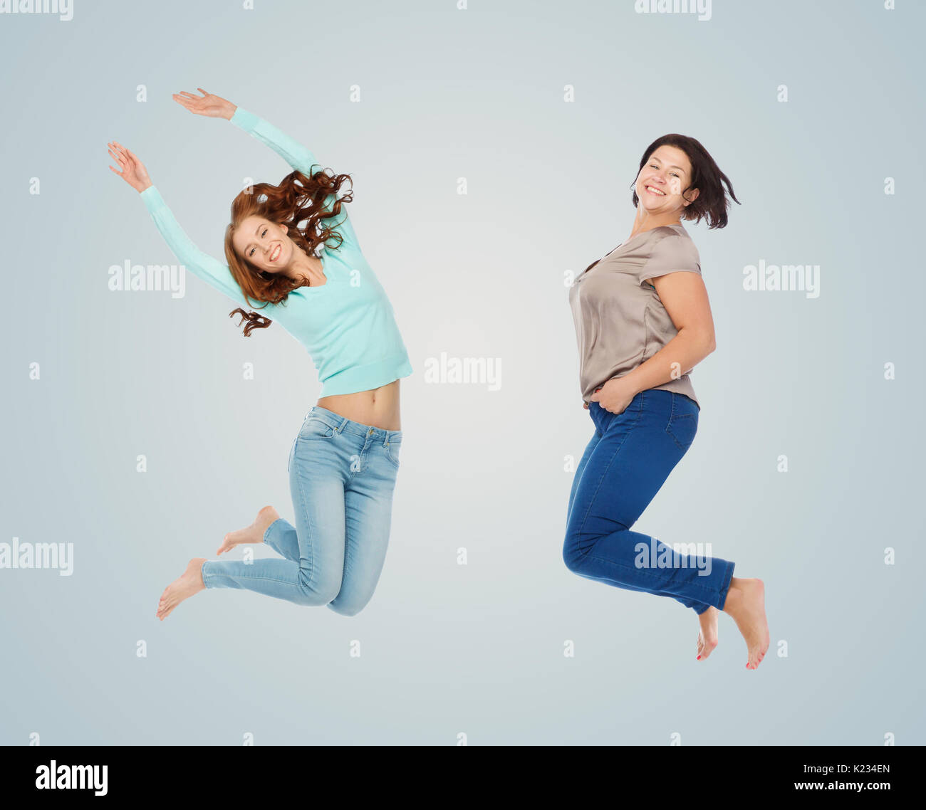 happy different women jumping over blue Stock Photo - Alamy