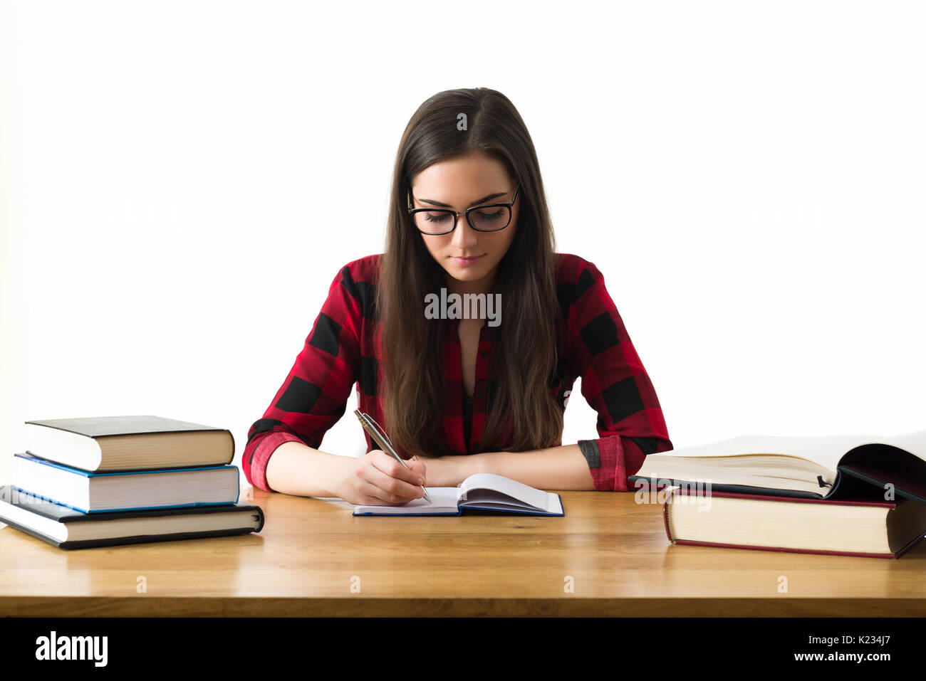 Attractive caucasian girl studying for her exams at home, education ...