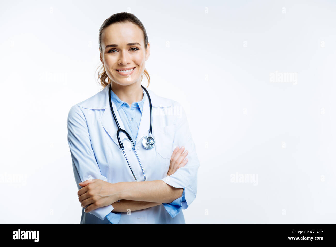 Beautiful female doctor smiling into camera Stock Photo - Alamy