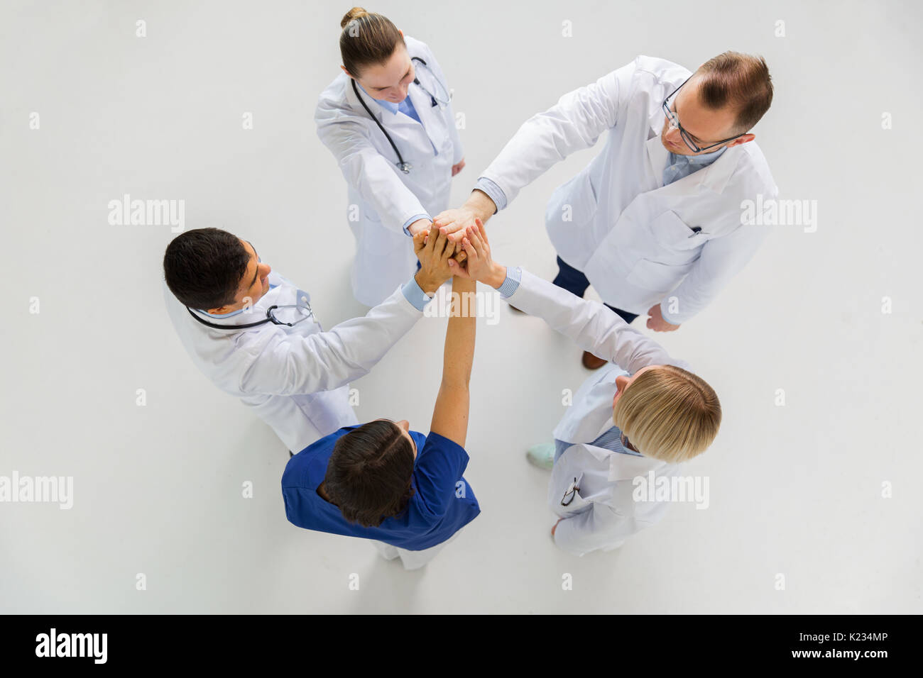 group of doctors making high five at hospital Stock Photo - Alamy