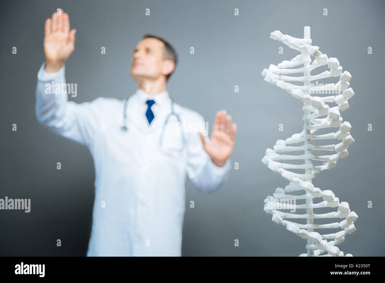Male scientist studying genetics over background Stock Photo - Alamy