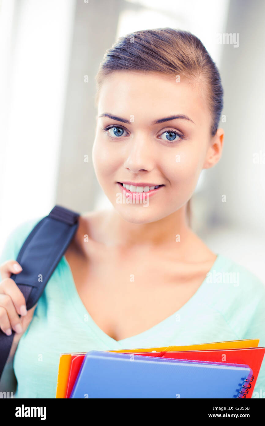 student girl with school bag and color folders Stock Photo - Alamy