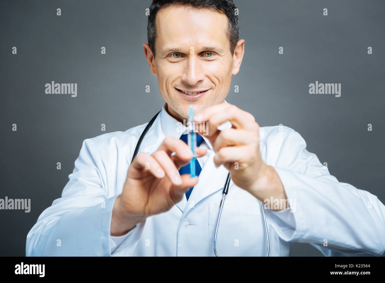 Radiant medical professional preparing for injection Stock Photo - Alamy