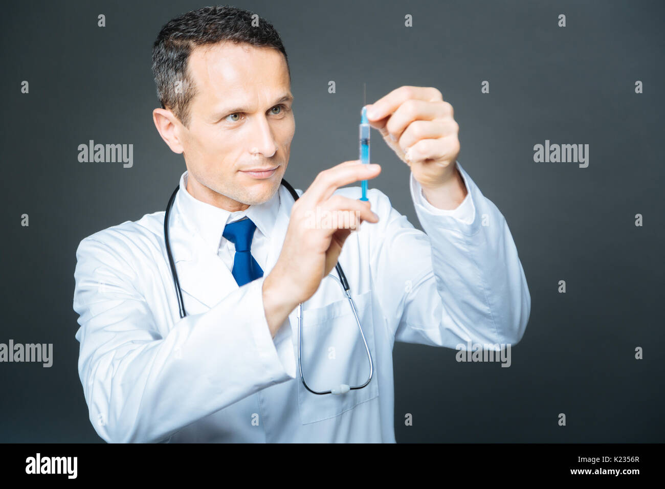 Doctor checking nurse injection hi-res stock photography and images - Alamy