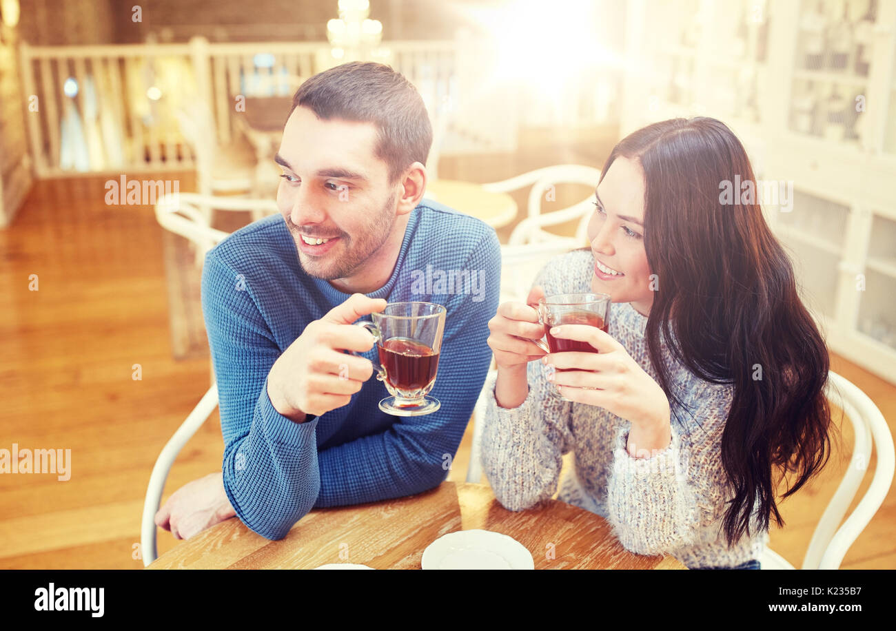 happy couple drinking tea at cafe Stock Photo - Alamy