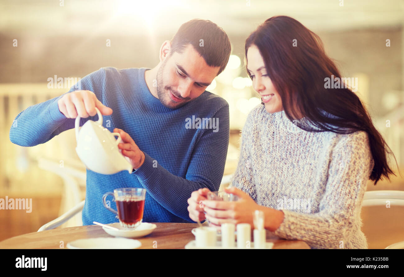 happy couple drinking tea at cafe Stock Photo - Alamy