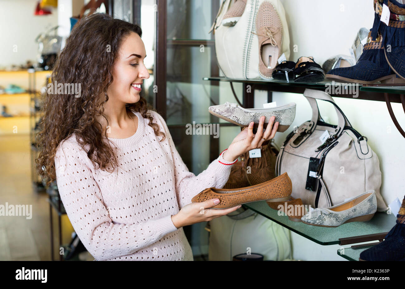 Young smiling beautiful woman shopping at fashion shoe store Stock ...
