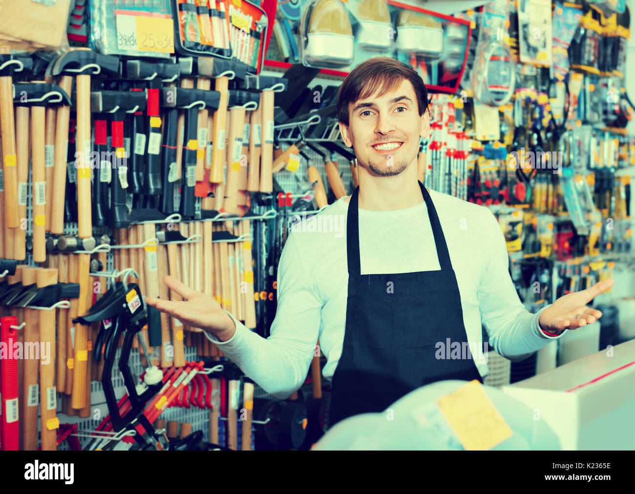 Professional friendly salesman working and smiling in building store ...