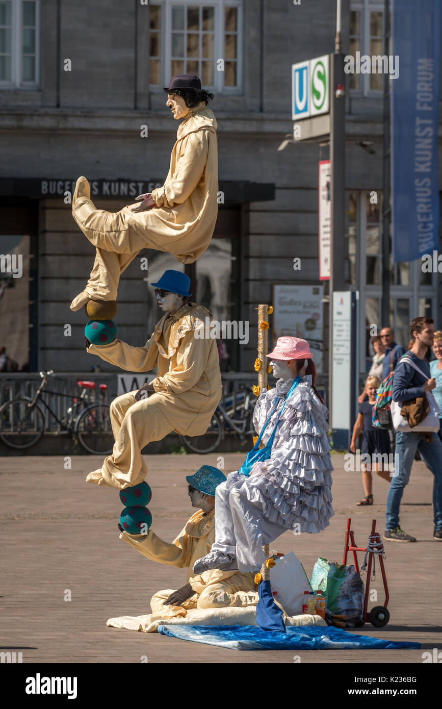 Street performers demonstrating an illusion outside the Rathaus in ...