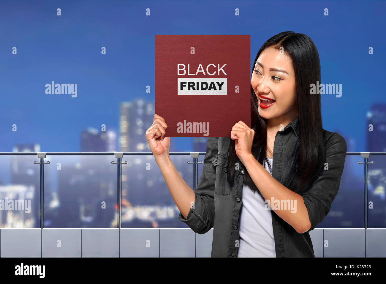 Happy asian woman holding board with Black Friday message over ...
