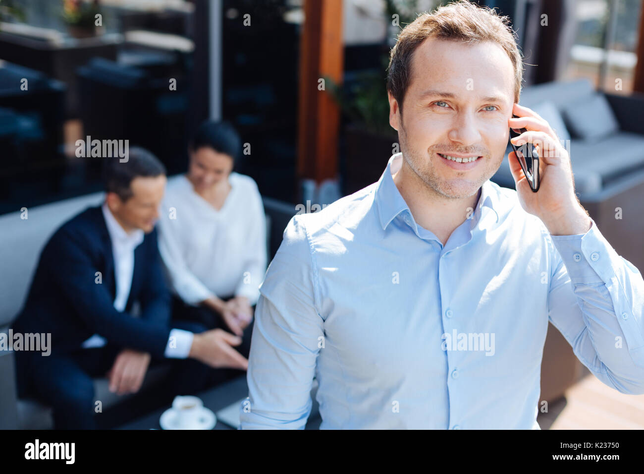 Happy delighted businessman making a call Stock Photo - Alamy