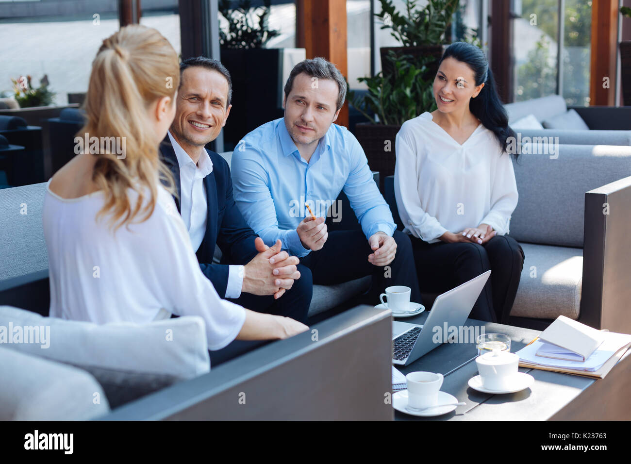 Joyful friendly colleagues meeting together Stock Photo - Alamy