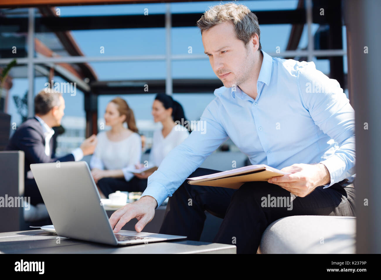 Handsome serious man working in the cafe Stock Photo - Alamy