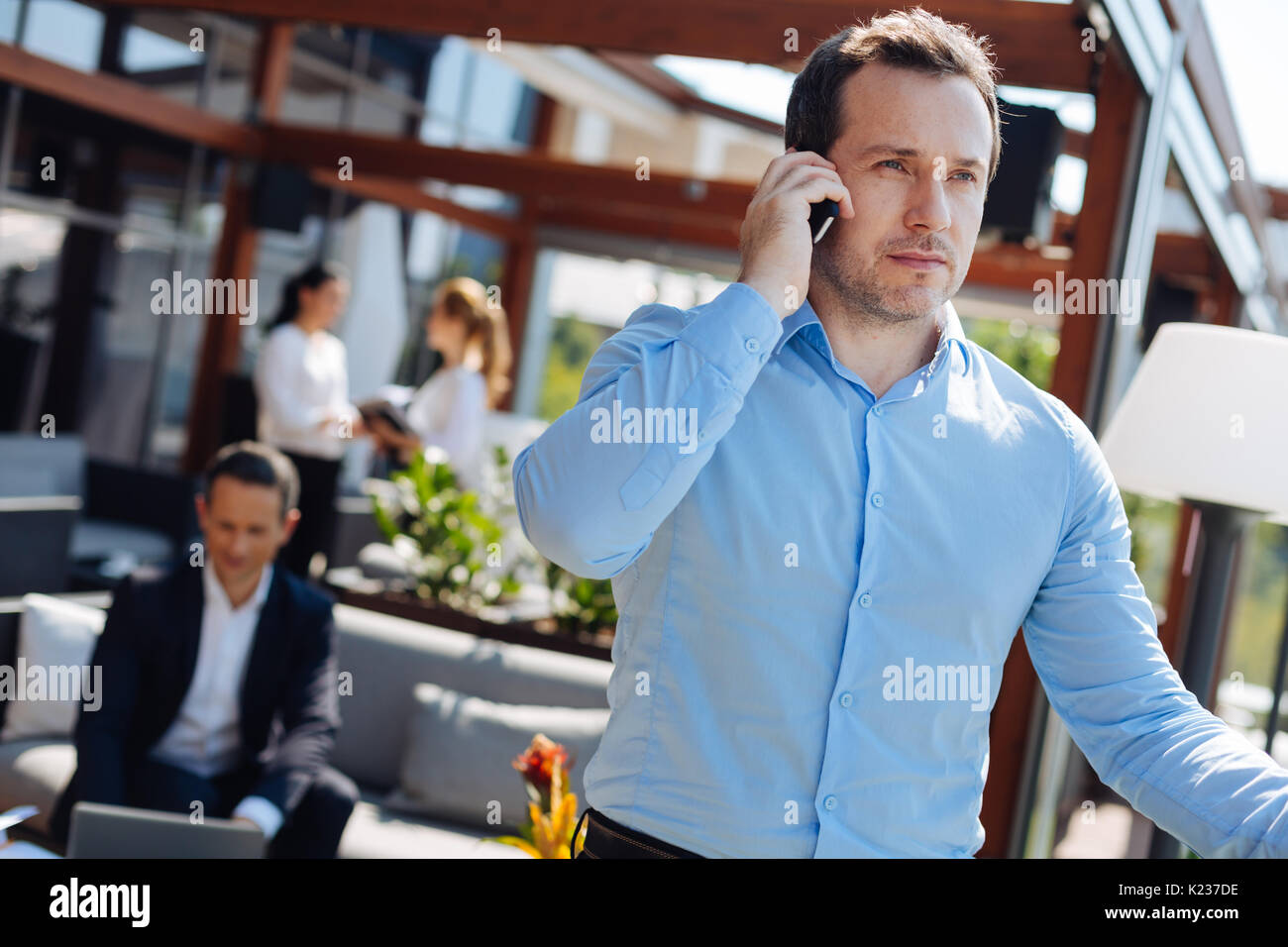 Confident serious man listening to his interlocutor Stock Photo - Alamy