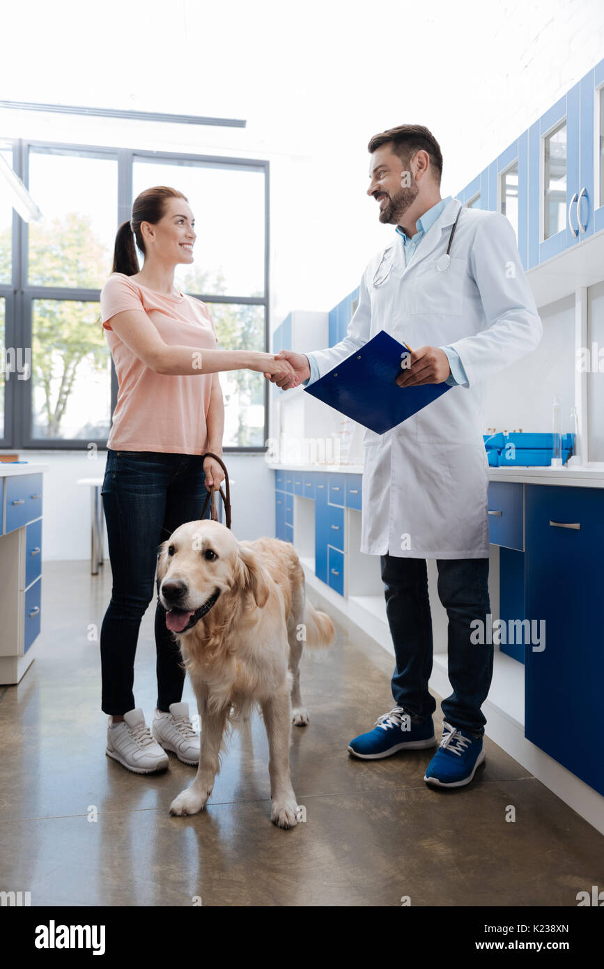 Attractive owner brought her dog for checkup Stock Photo - Alamy