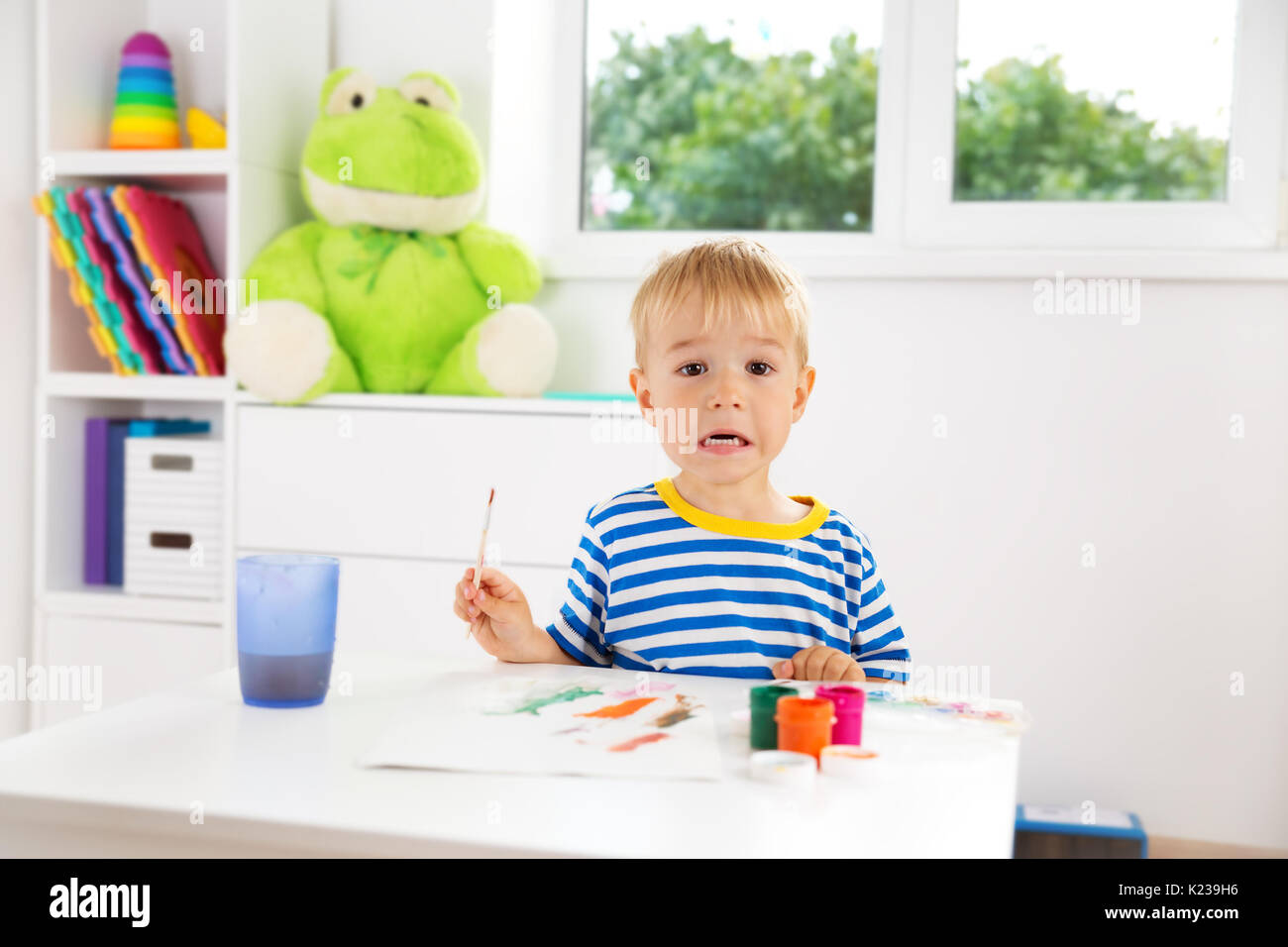 Little child drawing on the paper Stock Photo - Alamy
