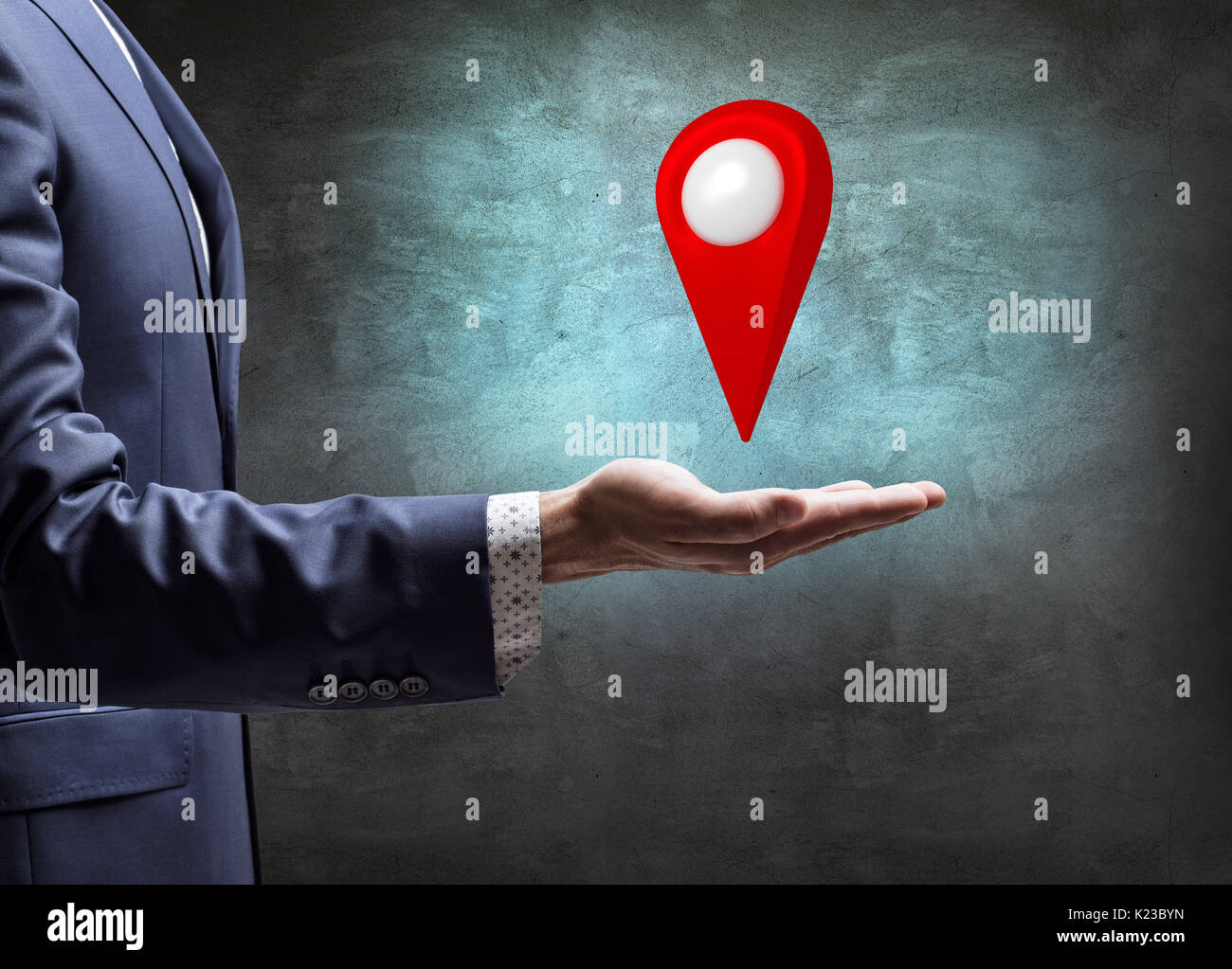Businessman holding indicating location icon Stock Photo - Alamy