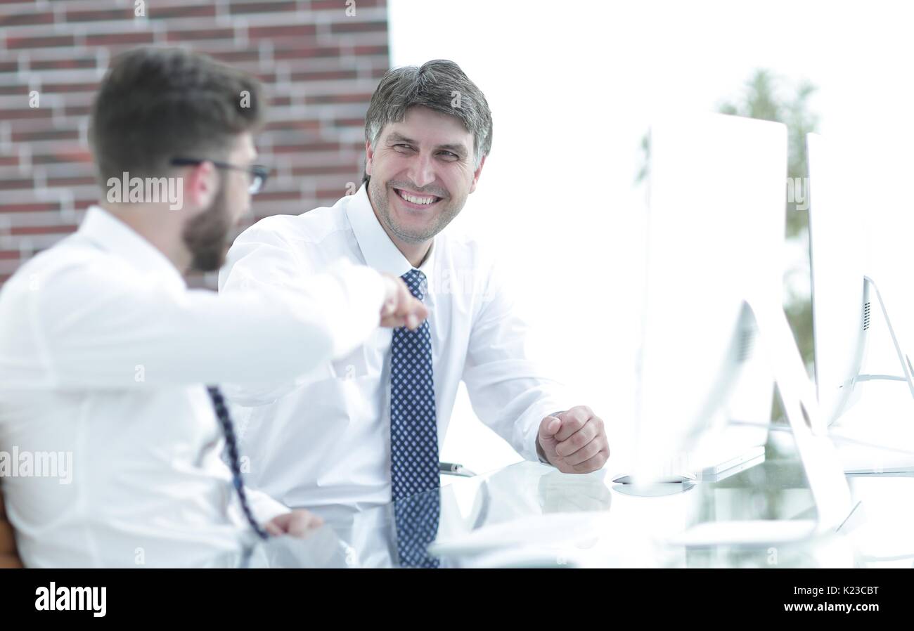 Smiling manager at his desk in the office Stock Photo - Alamy