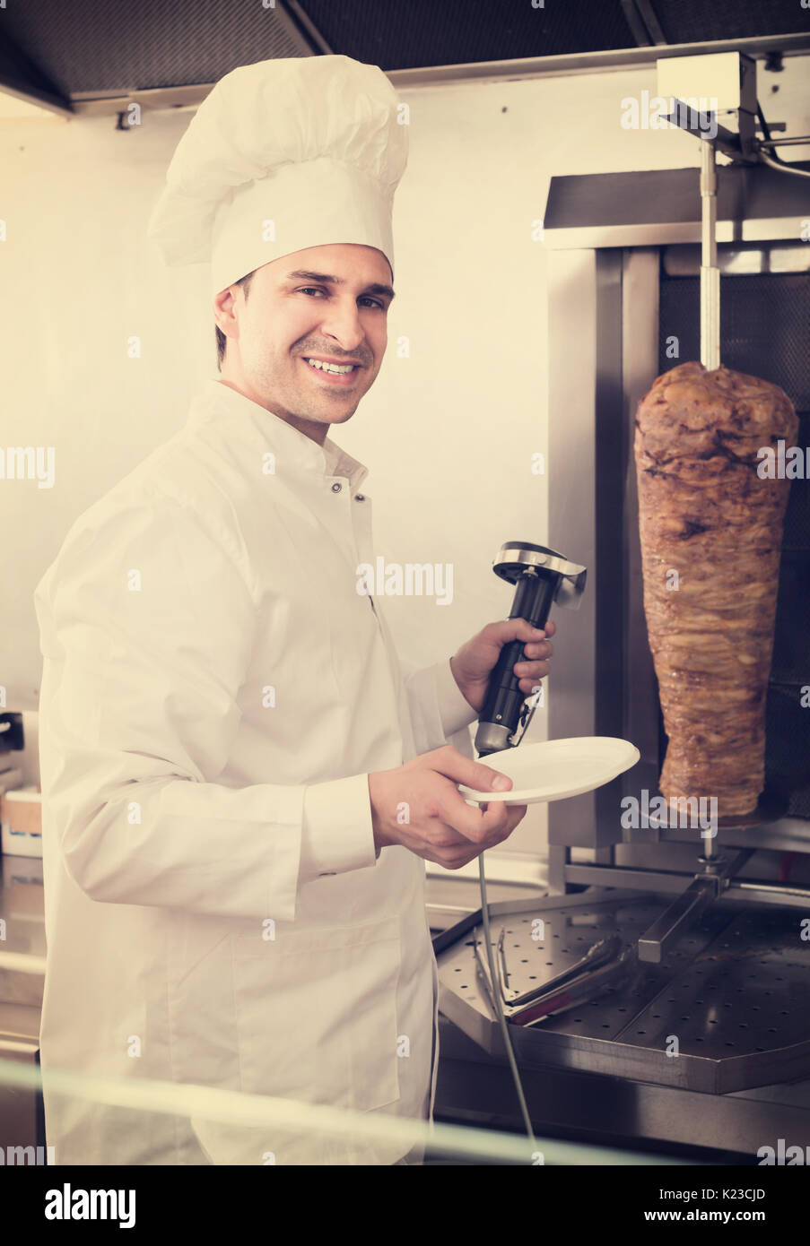 Ordinary arabian cook posing near meat for kebab and smiling Stock ...