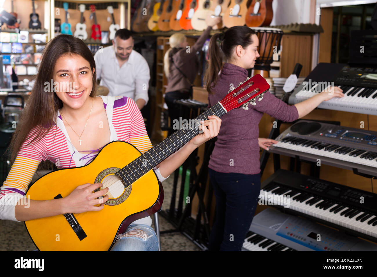 young guitarists making musical performance in store and smiling Stock ...