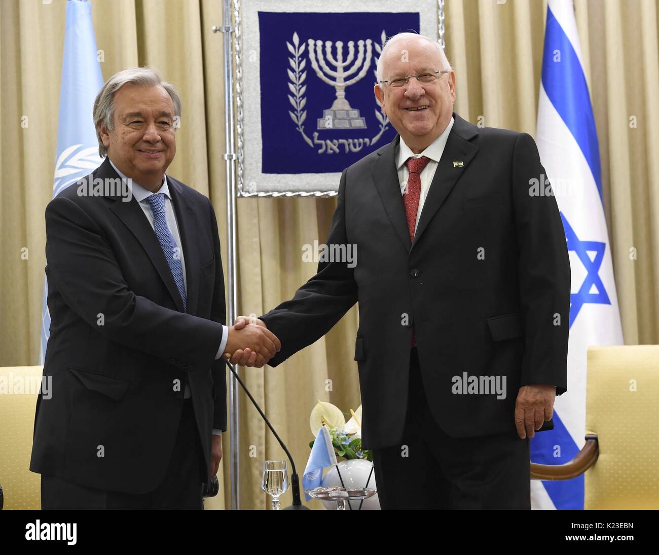 HANDOUT - Secretary general of UN, António Guterres (L) shakes hands with Israeli President ...