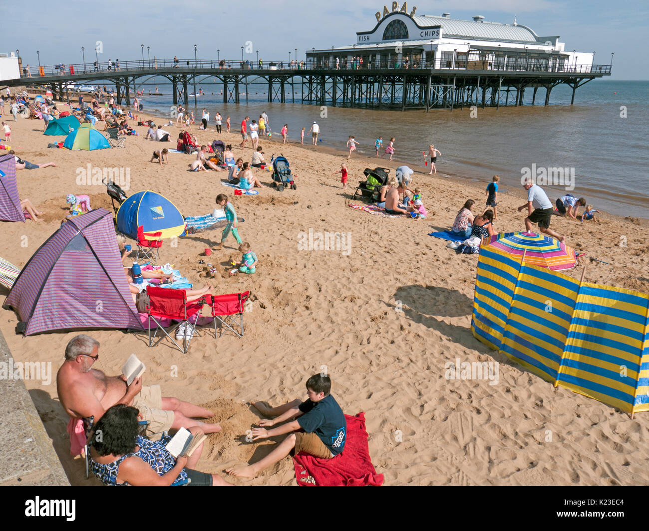 Holidaymakers sunbathing on cleethorpes beach, cleethorpes pier in ...