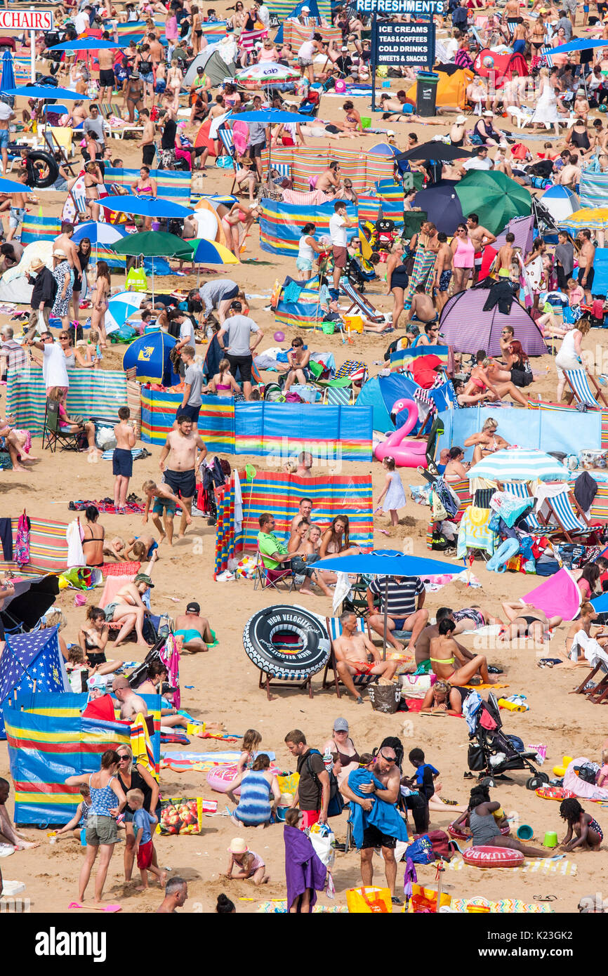 Summertime hot weather, resort beach crowded with people. Telephoto ...