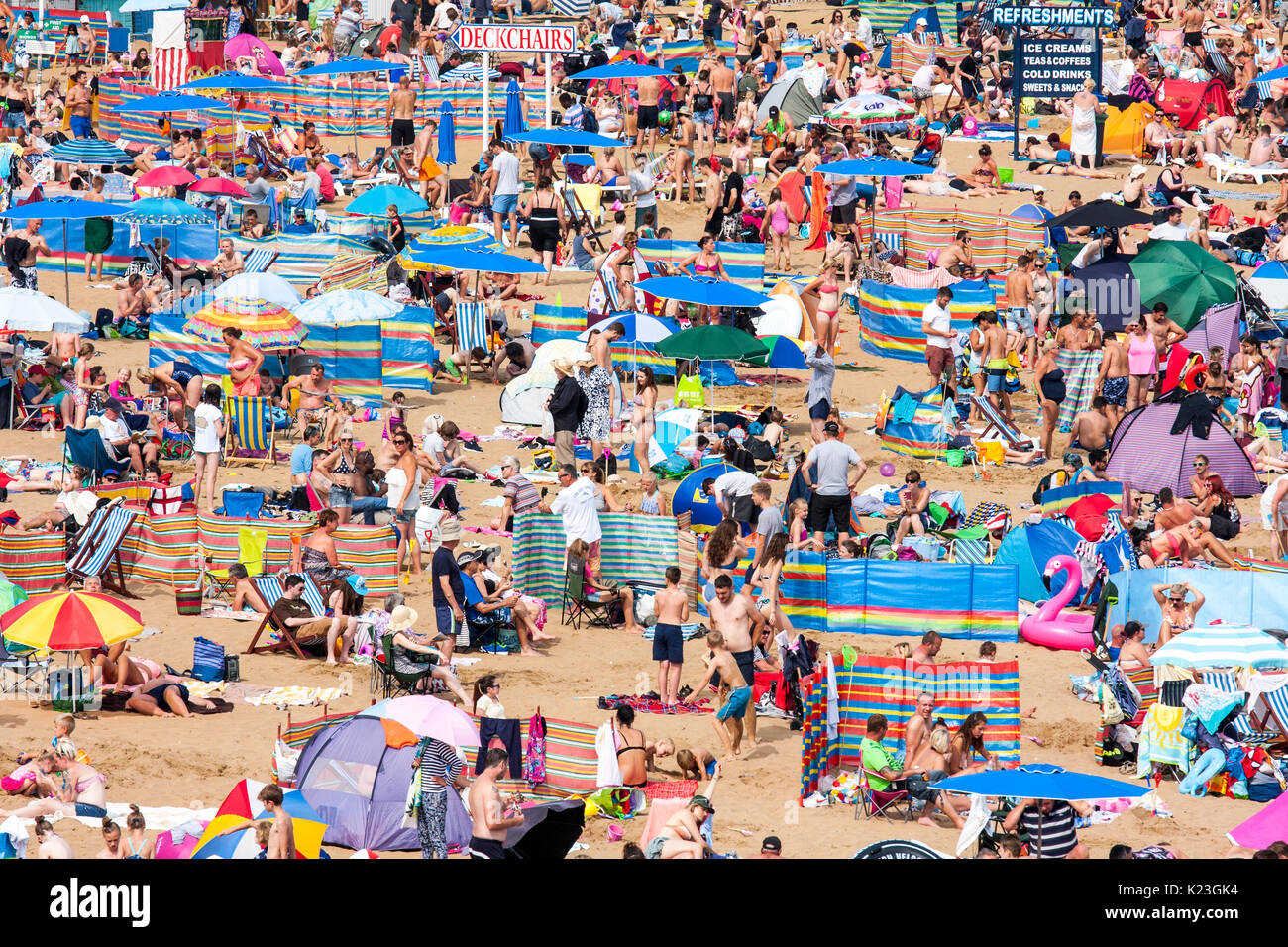 Summertime hot weather, resort beach crowded with people. Telephoto ...
