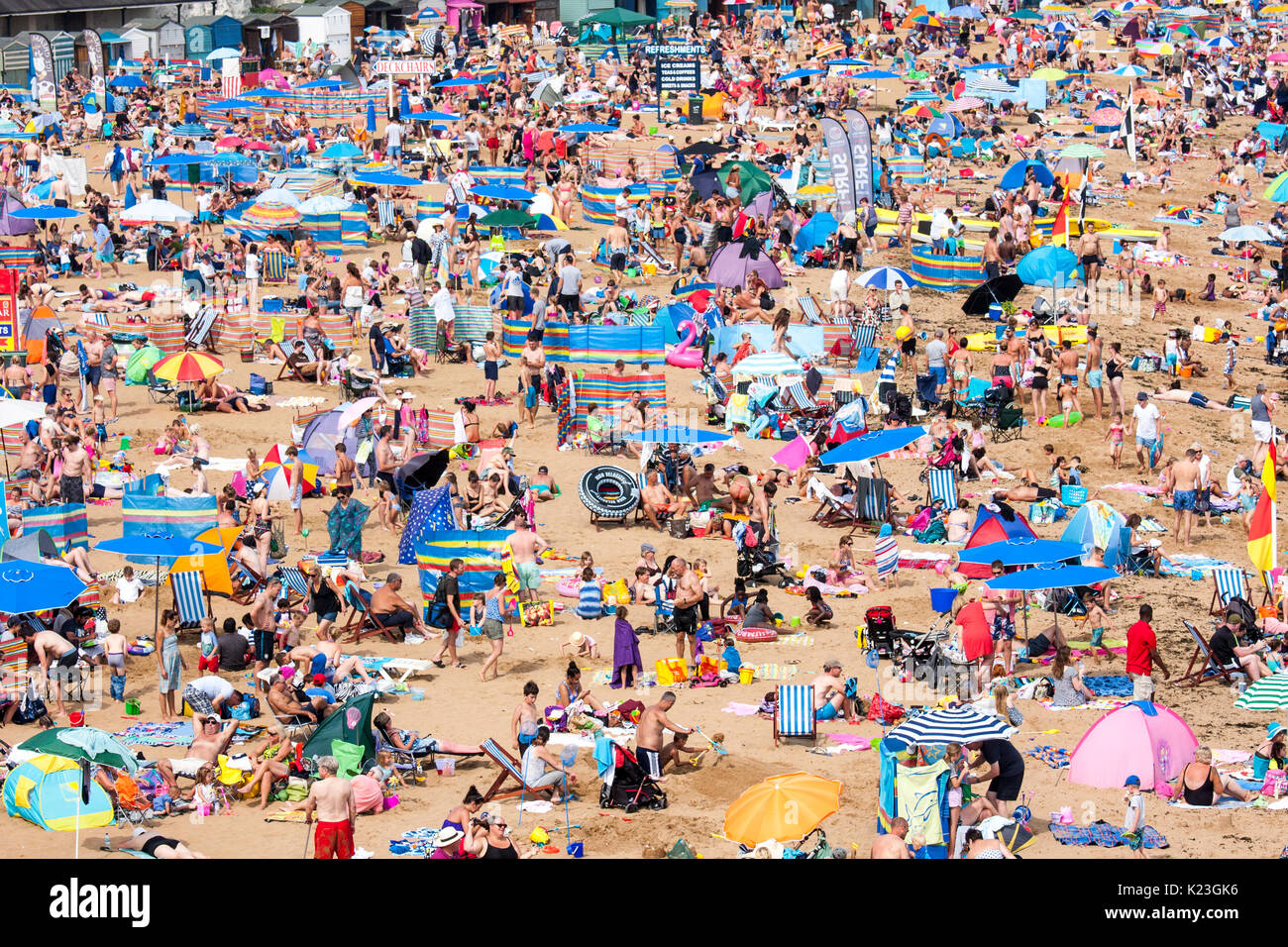 Summertime hot weather, resort beach crowded with people. Telephoto ...