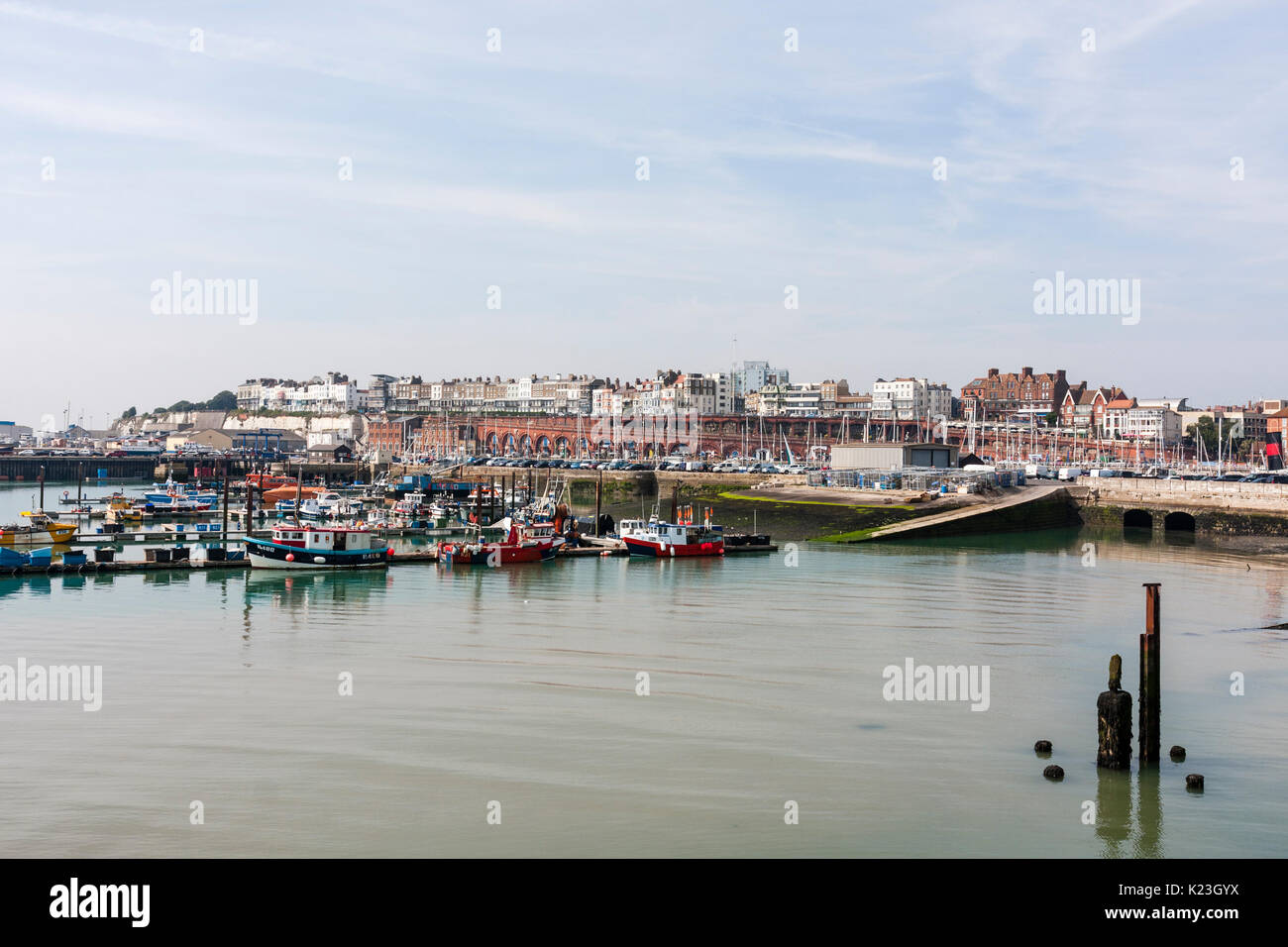 England, Ramsgate. Ramsgate harbour in the daytime with calm sea. Town ...
