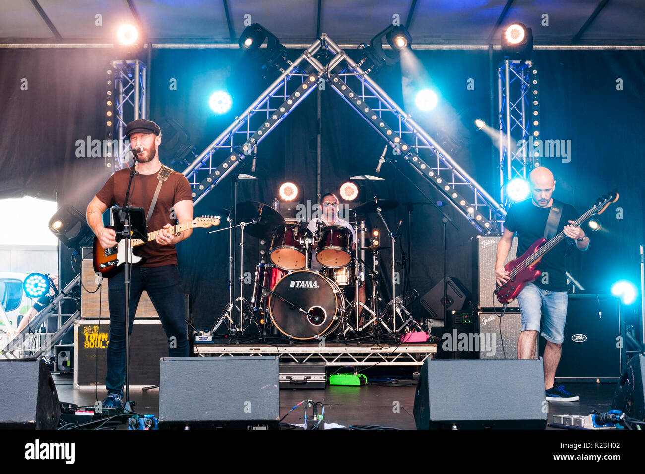 Facing view with no audience in picture, three man rock band NSE ...