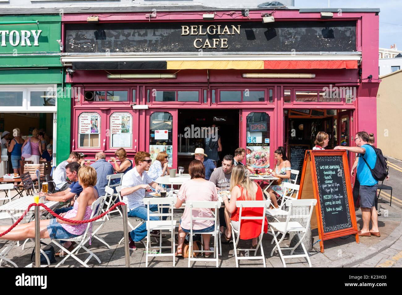 England, Ramsgate. People sitting outside the Belgian Cafe at tables ...