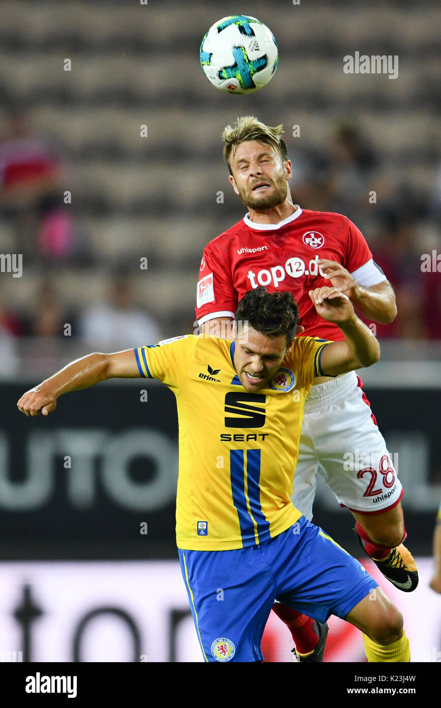 Kaiserslautern's Daniel Halfar (top) heads the ball above Braunschweig ...