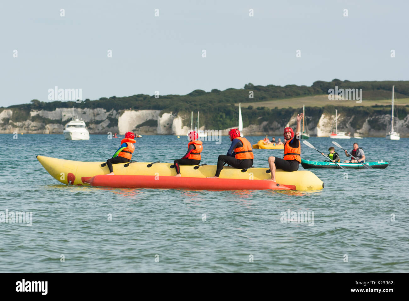 Riding a banana boat, Shell Bay, Dorset in summer, August school ...