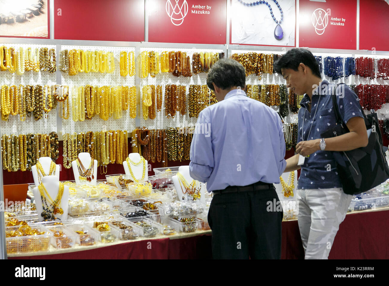 Visitors look at the jewellery products on display during the Japan ...