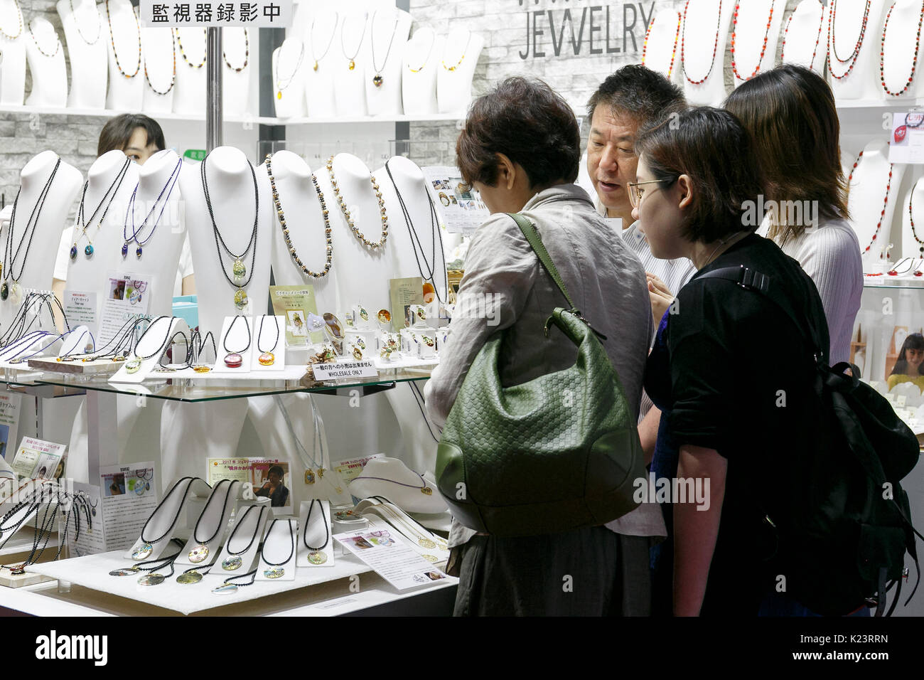 Visitors look at the jewellery products on display during the Japan ...