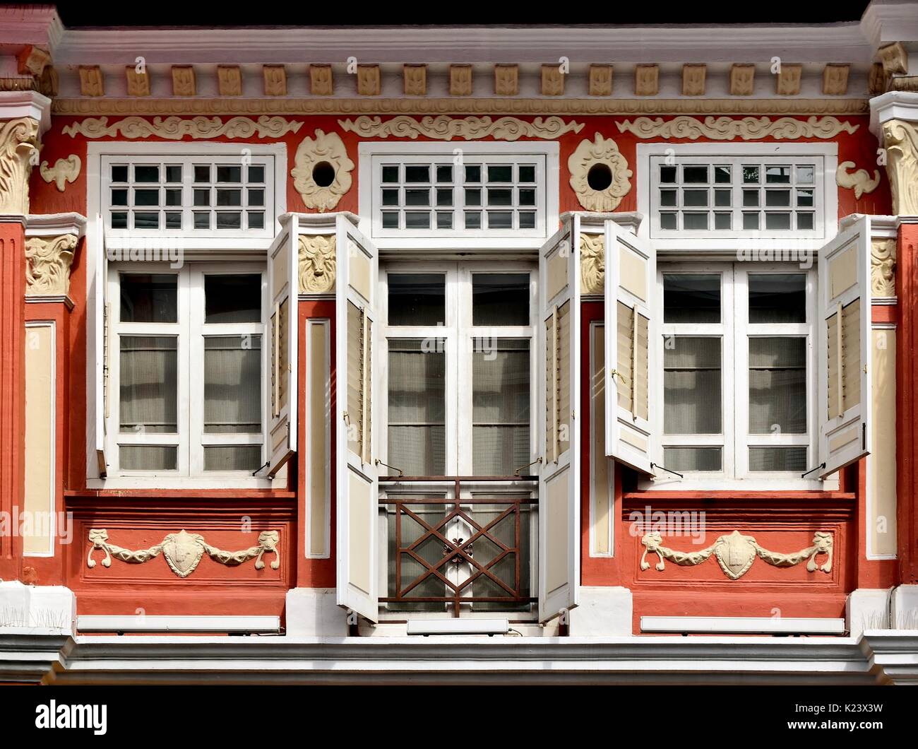 Traditional shop house exterior with white wooden louvered shutters ...