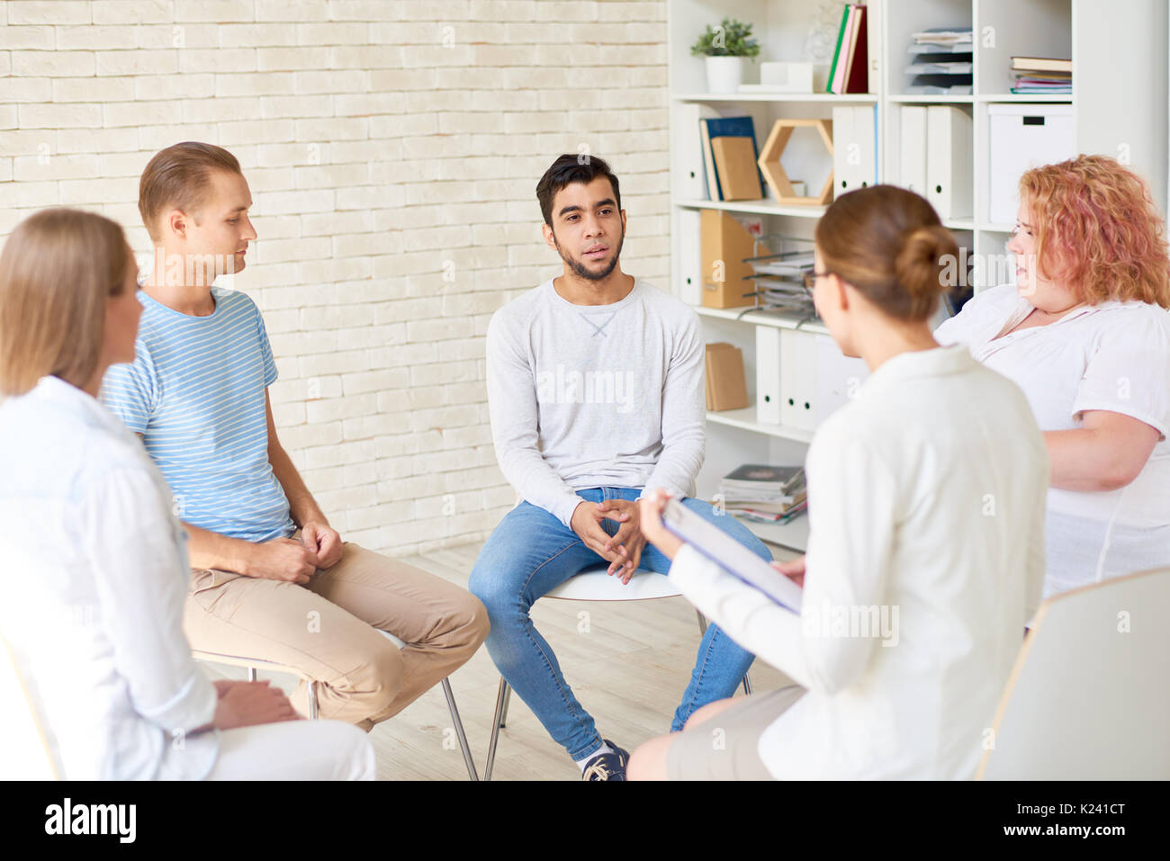 Young People in Group Therapy Session Stock Photo - Alamy