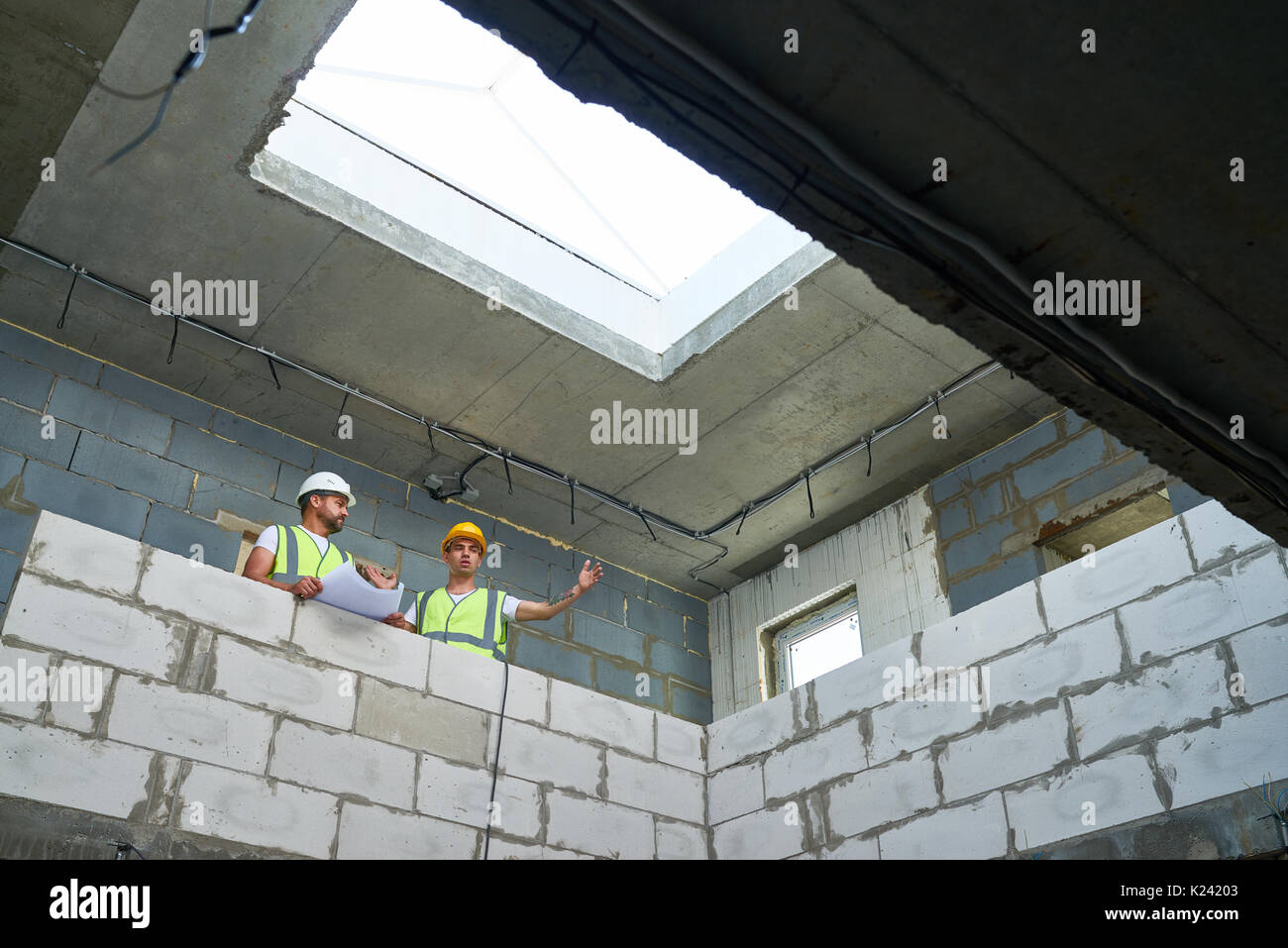Builders on Construction Site Stock Photo - Alamy