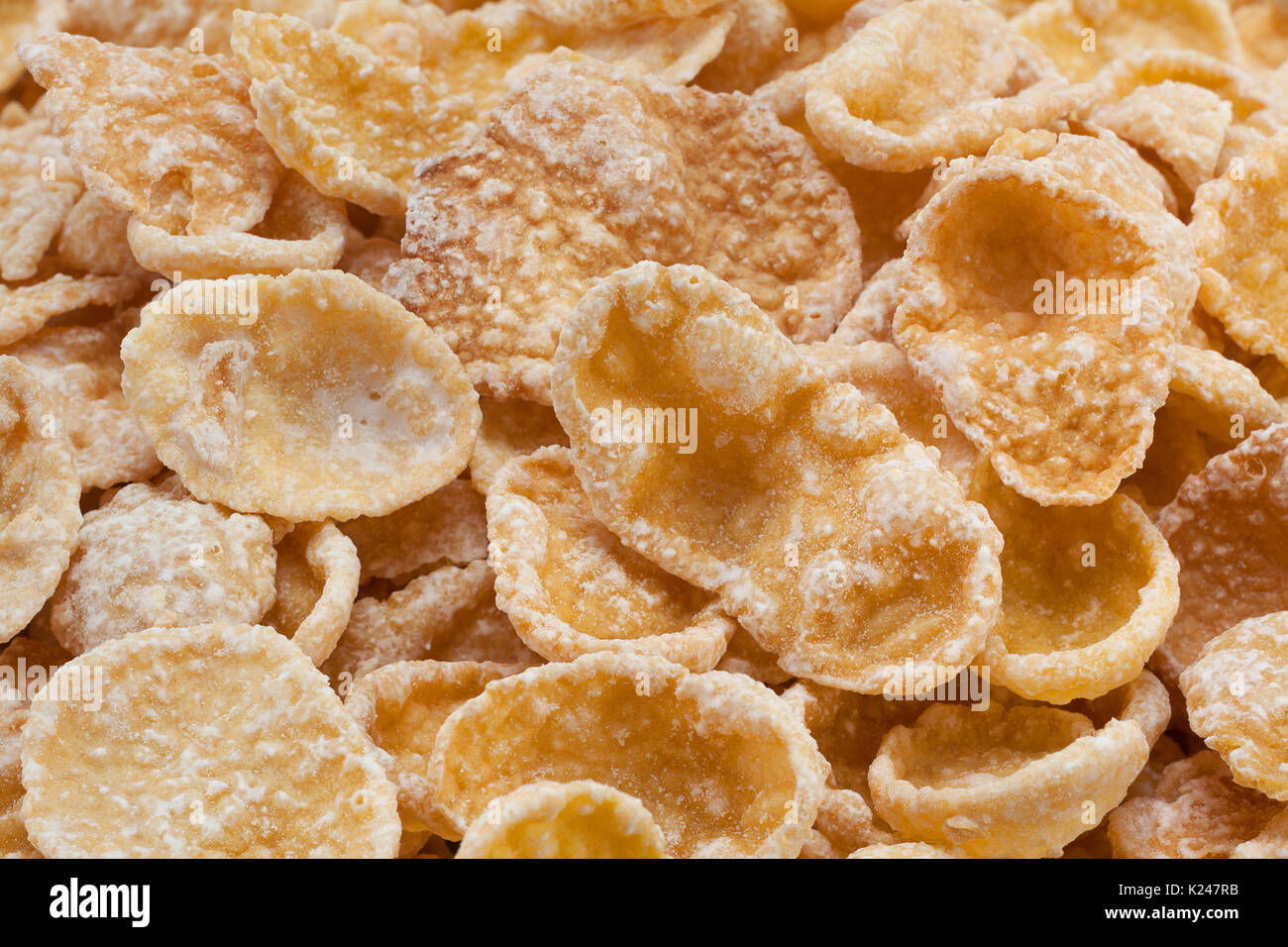 Sweet corn flakes in sugar glazed closeup background Stock Photo - Alamy