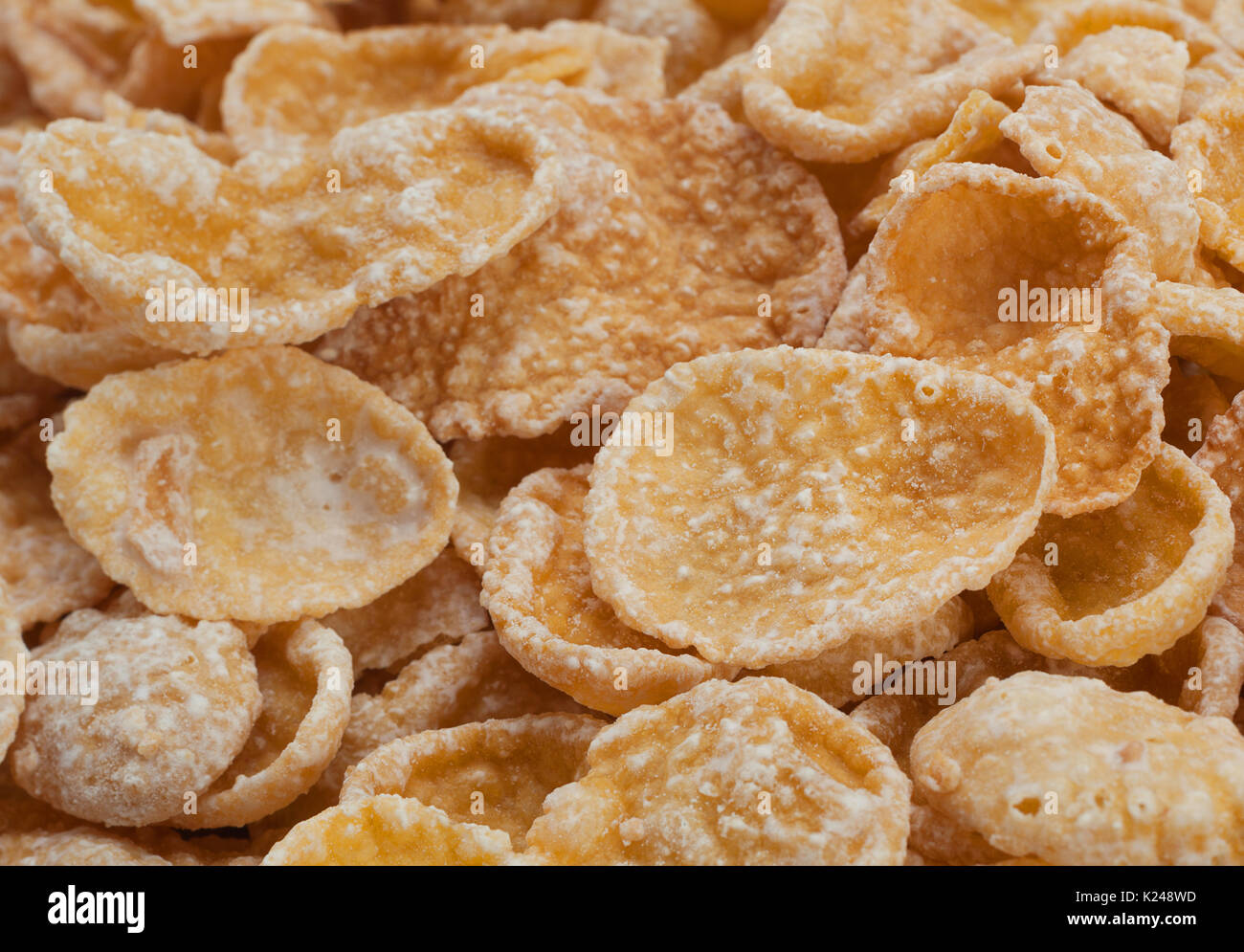 Sweet corn flakes in sugar glazed closeup background Stock Photo - Alamy