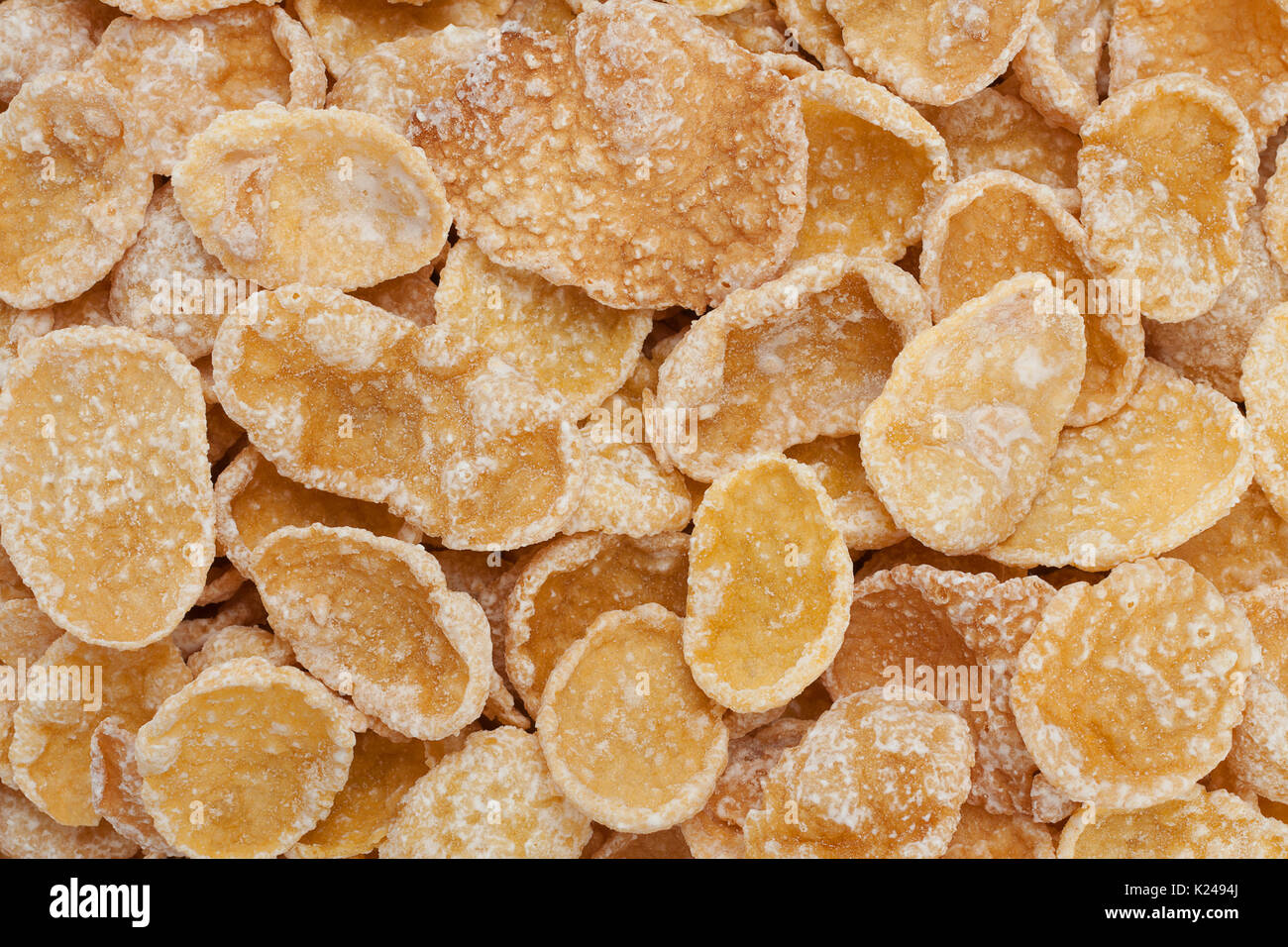 Sweet corn flakes in sugar glazed closeup background Stock Photo - Alamy