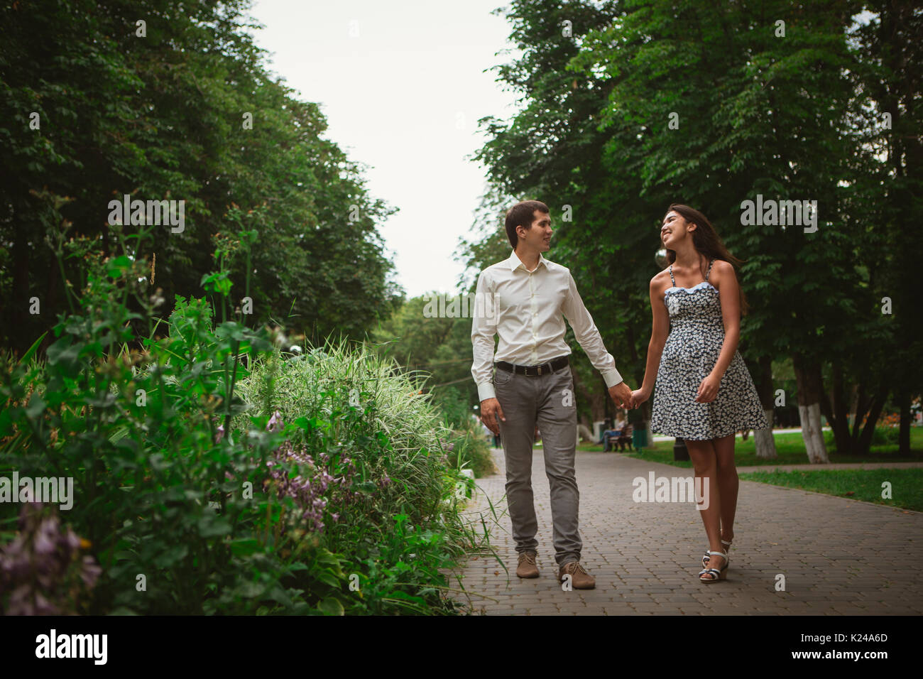 Beautiful young couple on a nature background Stock Photo - Alamy