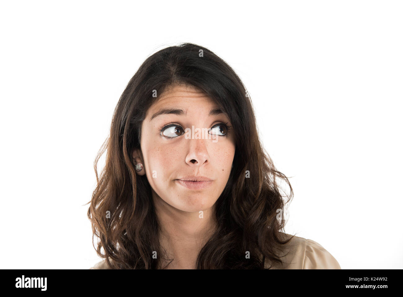 A young girl looks to the side with a doubtful face Stock Photo - Alamy