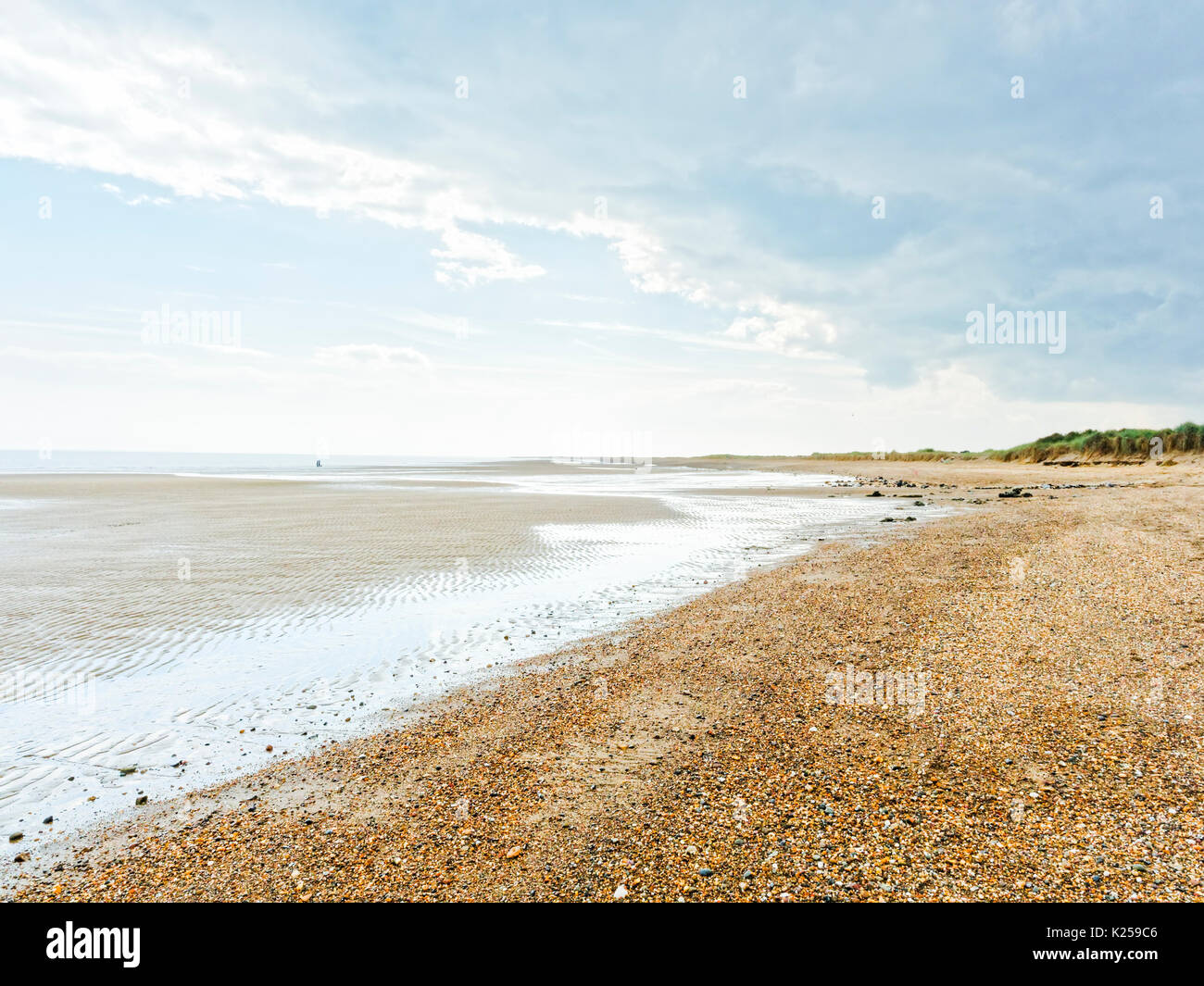 The sun brightens Skegness beach as dark clouds linger overhead Stock ...