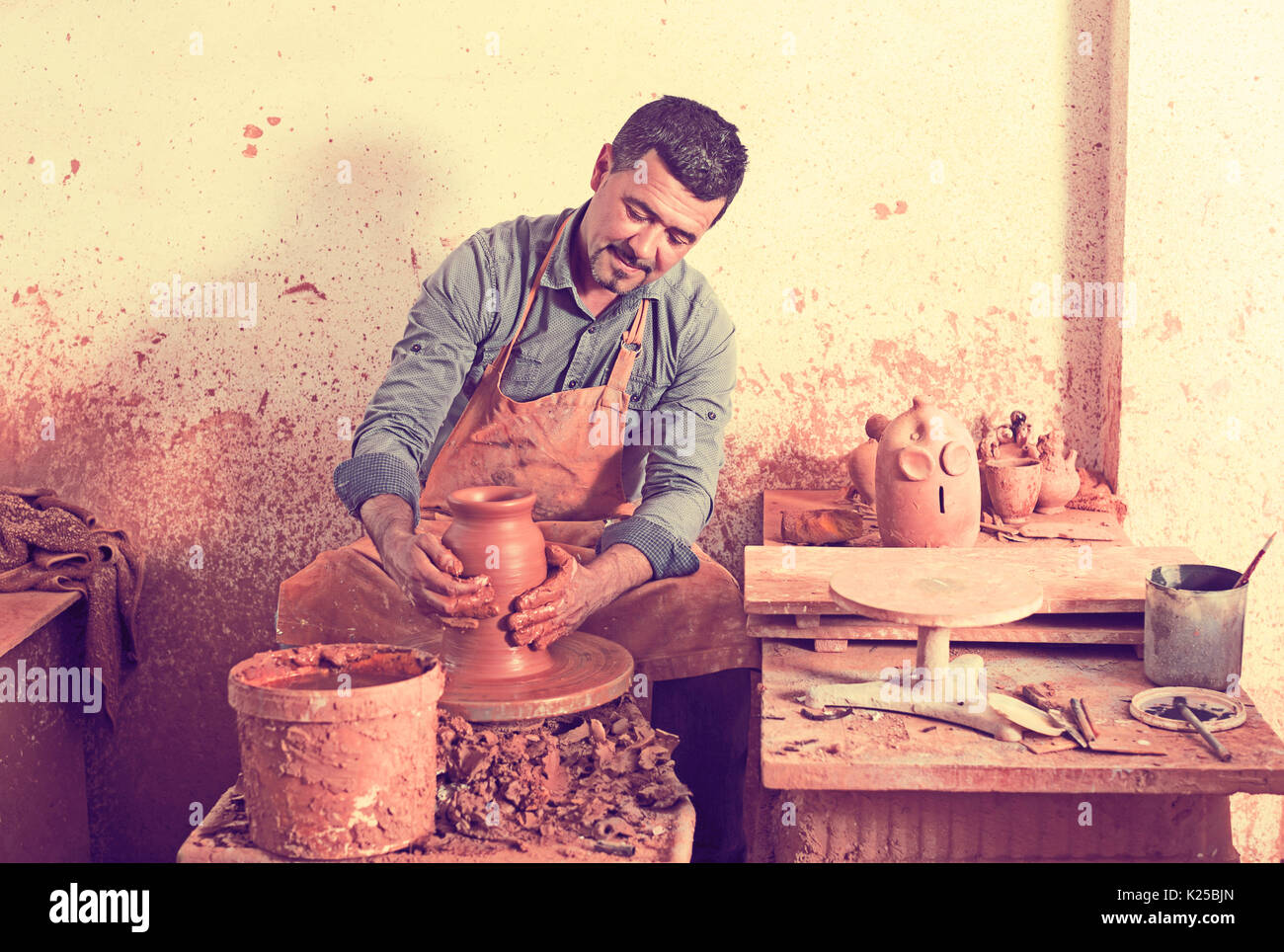 Happy elderly man making pot using pottery wheel in studio Stock Photo ...