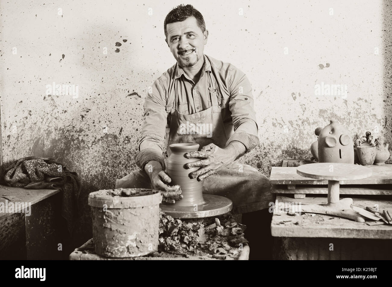 Happy mature man making pot using pottery wheel in studio Stock Photo ...