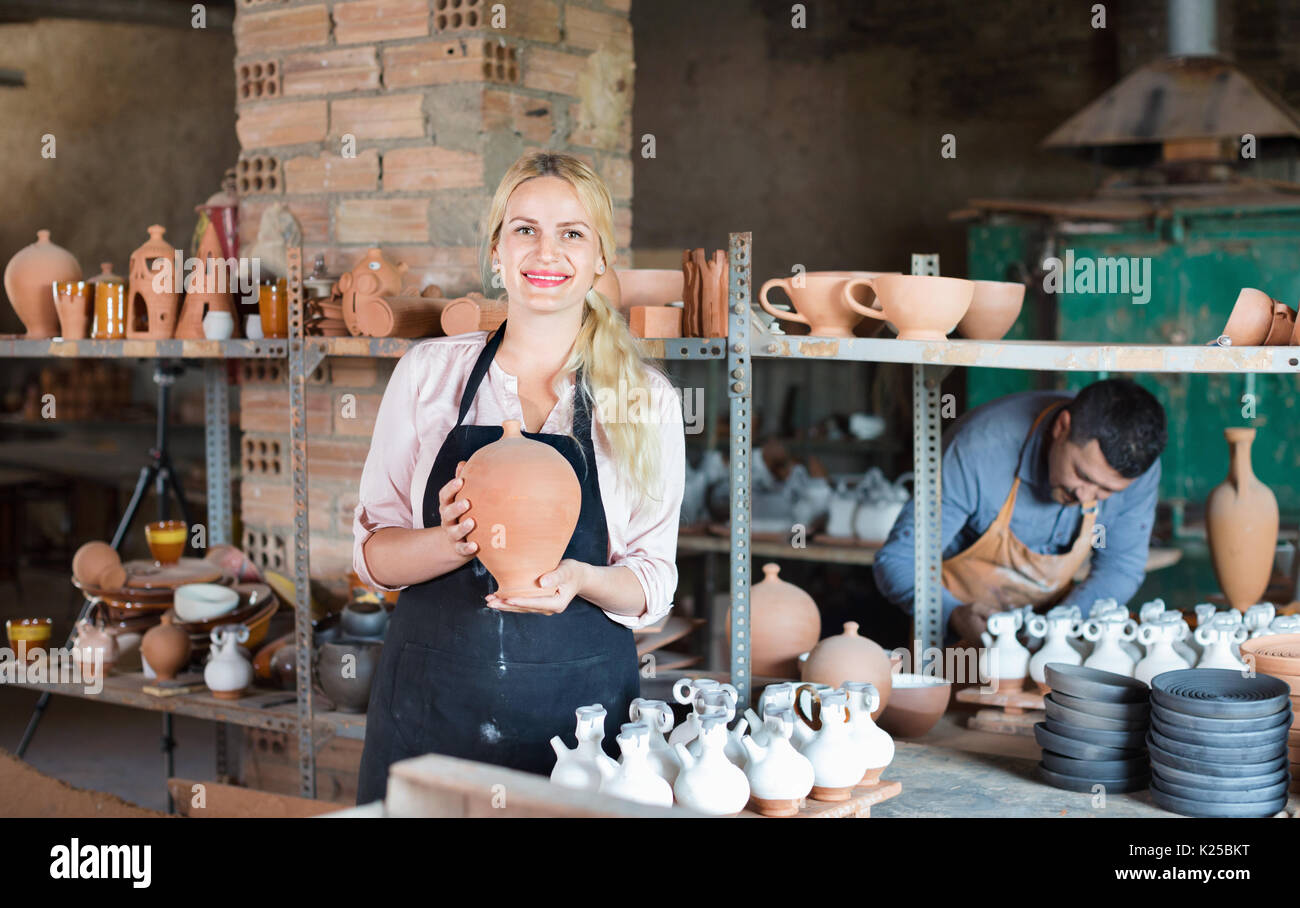 Portrait of pleasant efficient woman pottery worker with ceramic ...