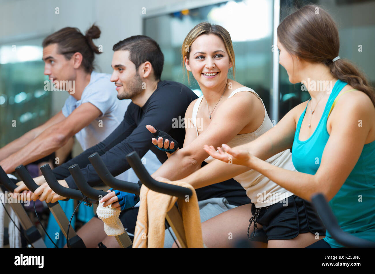 Group smiling working out of cycling in modern fitness club Stock Photo ...