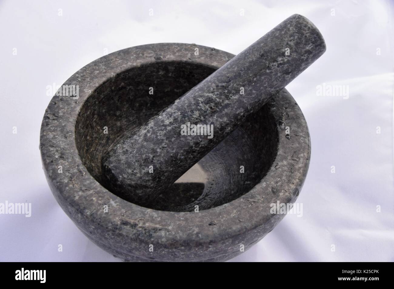 Mortar and pestle made of black marble or granite, grind the spices ...